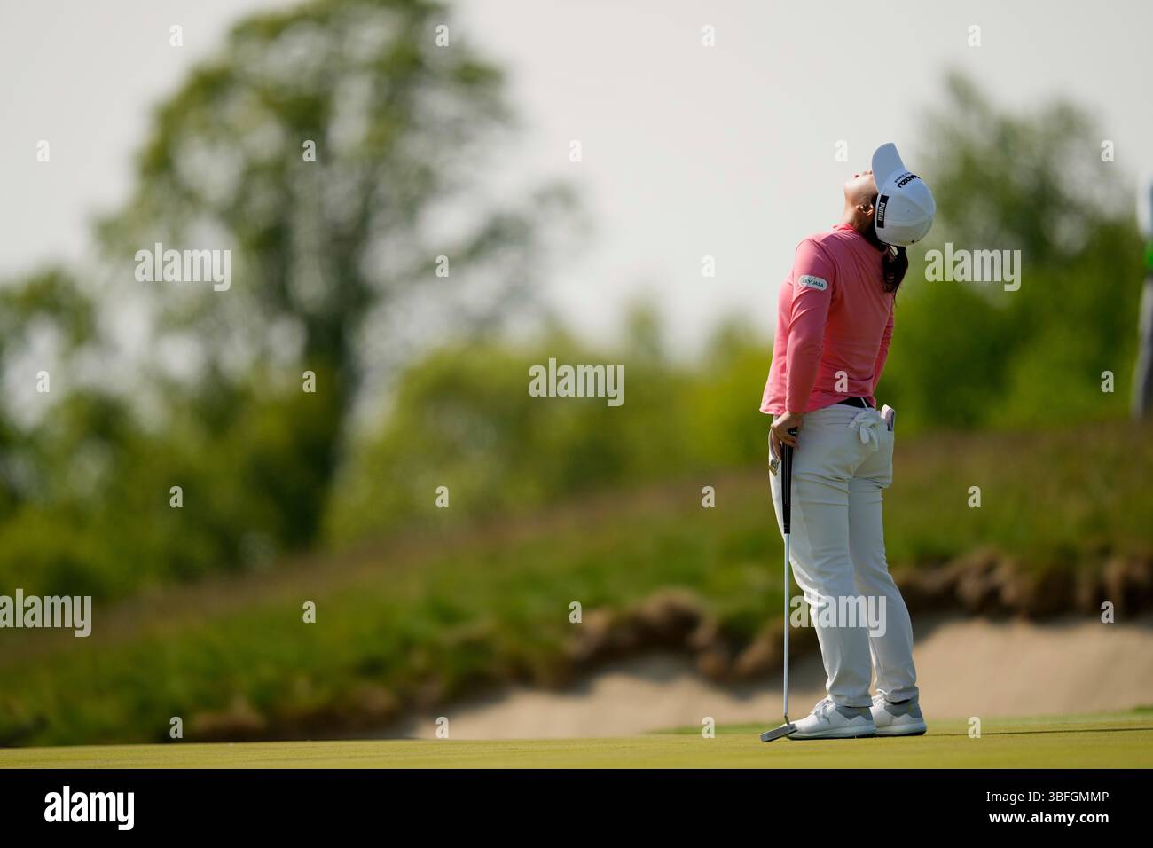 Mao Saigo, of Japan, reacts to a missed putt during the fourth round of ...