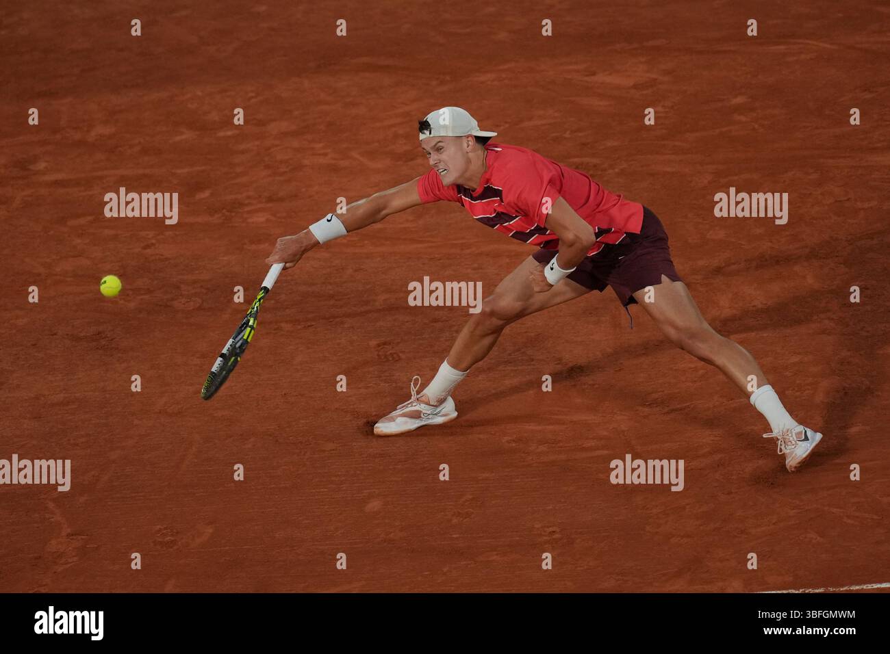 Denmark's Holger Rune returns the ball to Italy's Lorenzo Musetti during their fourth round ...