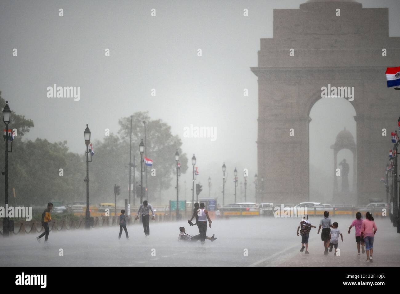 NEW DELHI, INDIA - JUNE1: People seen enjoying heavy rainfall at India Gate, on June 1, 2025 in ...