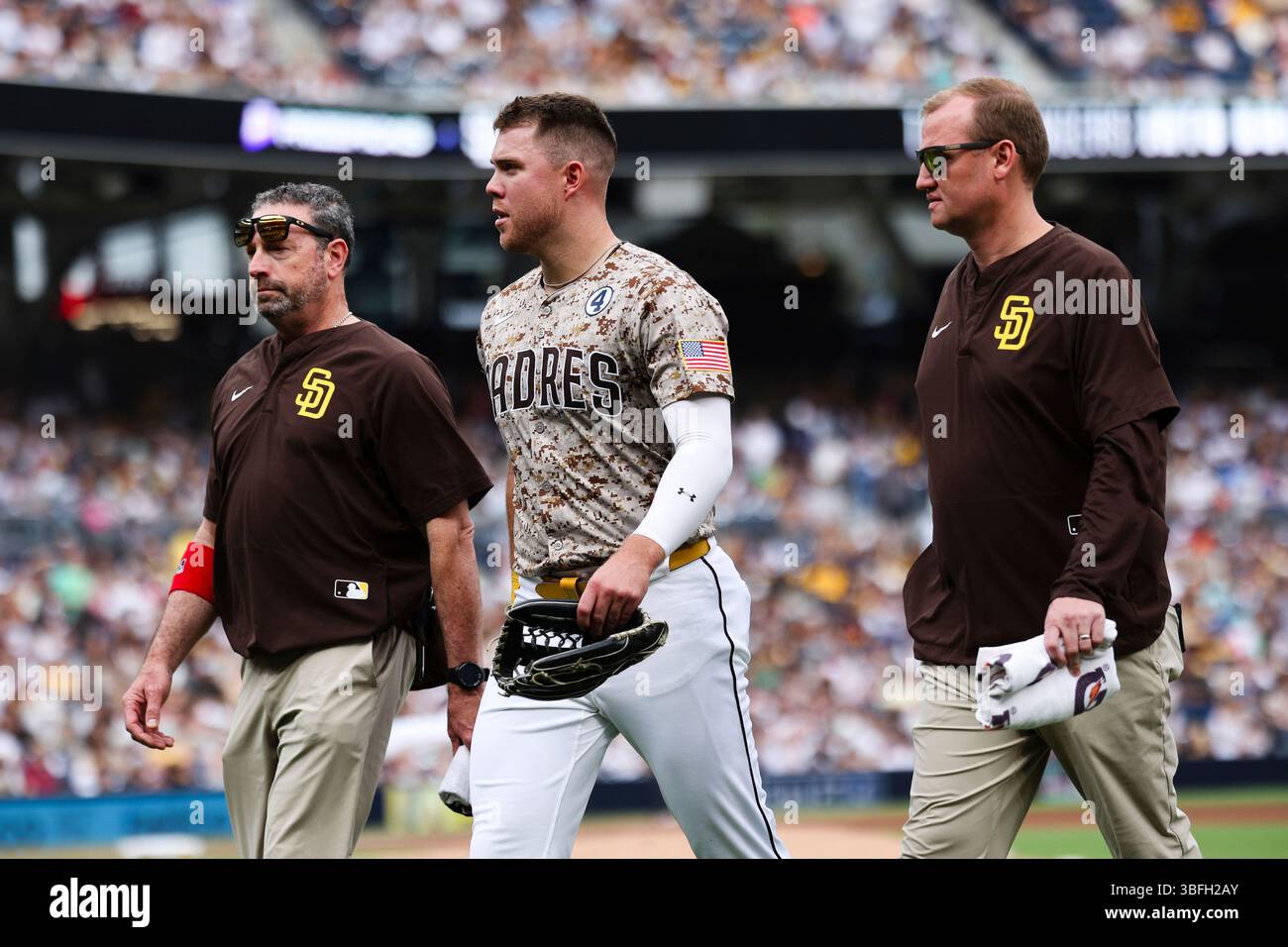 San Diego Padres' Gavin Sheets, center, walks off the field with ...