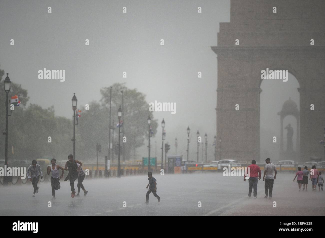 NEW DELHI, INDIA - JUNE1: People seen enjoying heavy rainfall at India Gate, on June 1, 2025 in ...