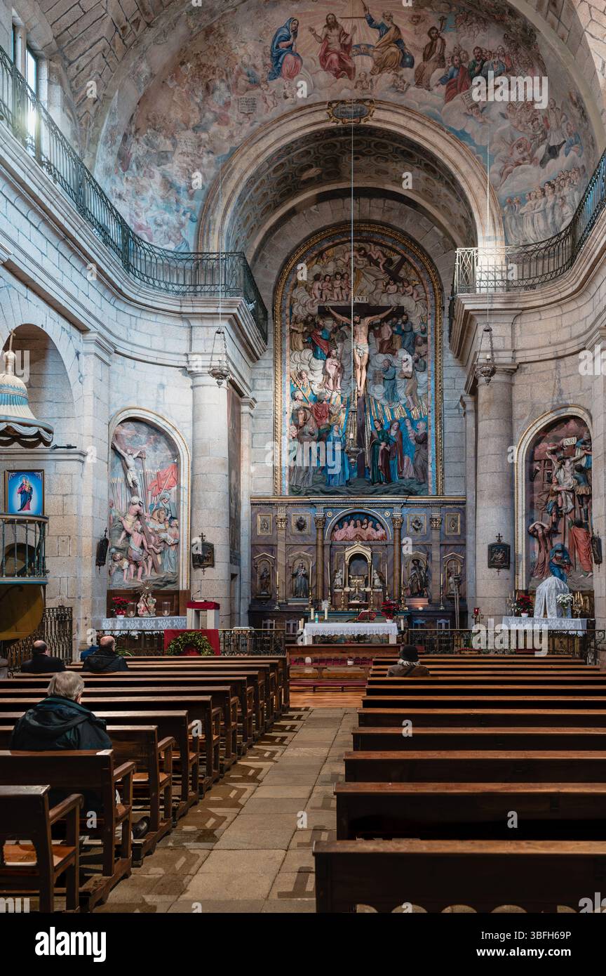 Church interior featuring frescoes, altar, pews, and worshippers ...