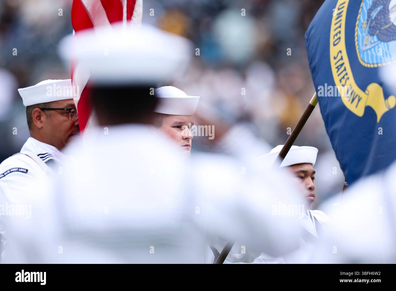 Members of the United States Navy color guard stand at attention during ...