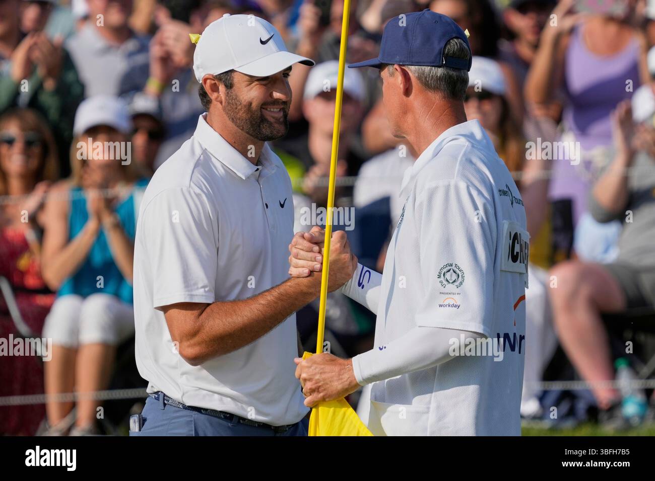 Scottie Scheffler, left, celebrates with his caddie Ted Scott, right ...