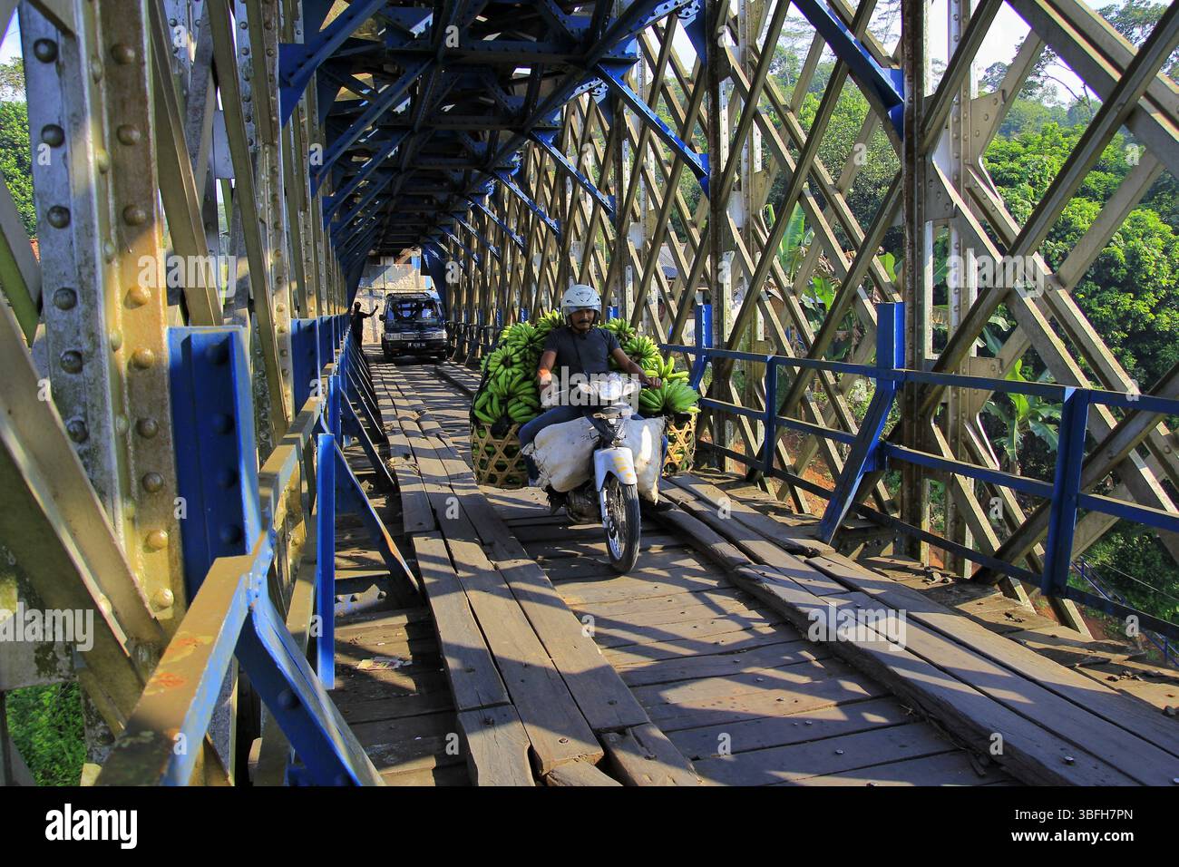 Residents cross the Cirahong bridge which connects Tasikmalaya and ...