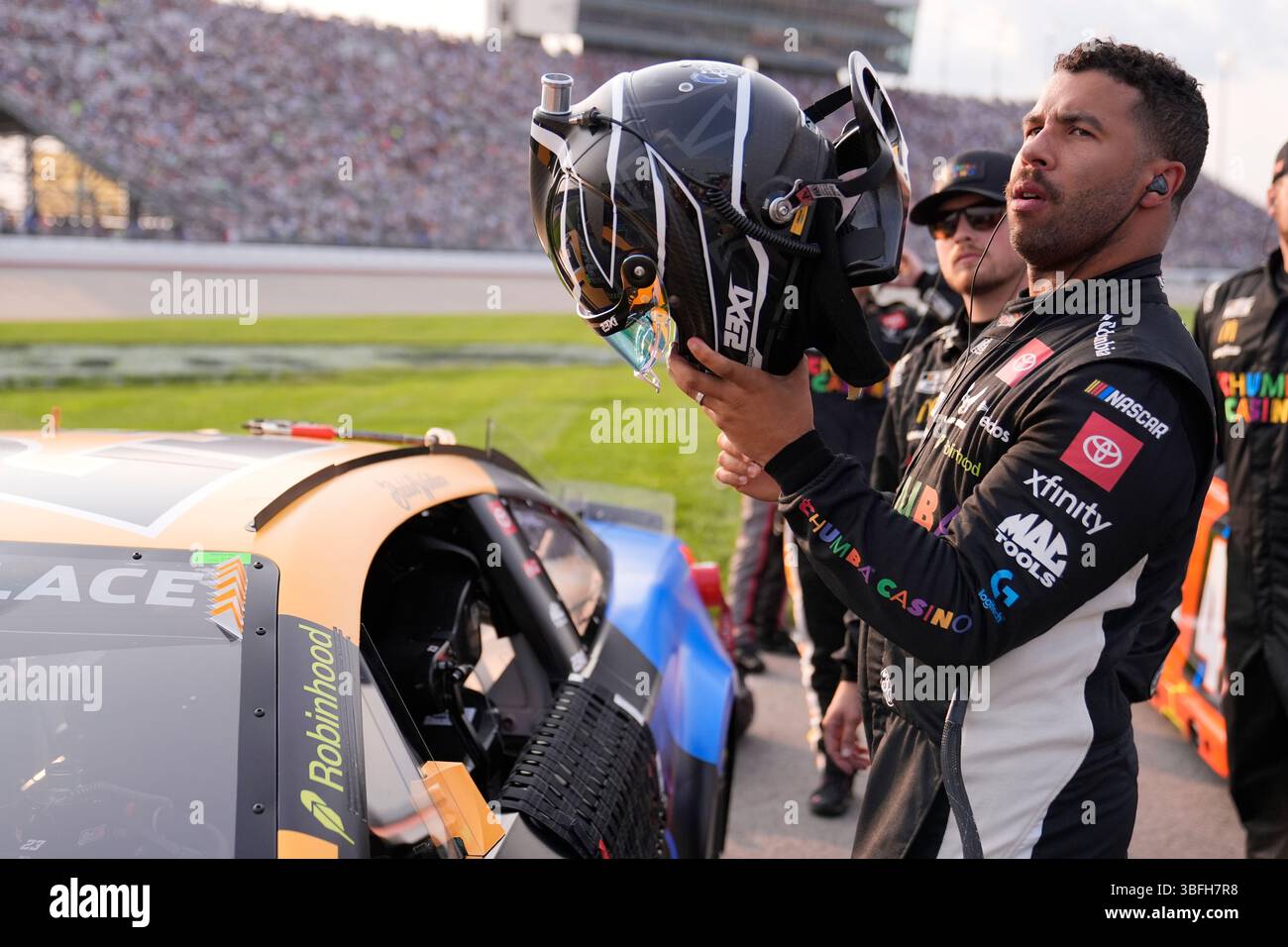 Bubba Wallace puts on his helmet before a NASCAR Cup Series auto race ...