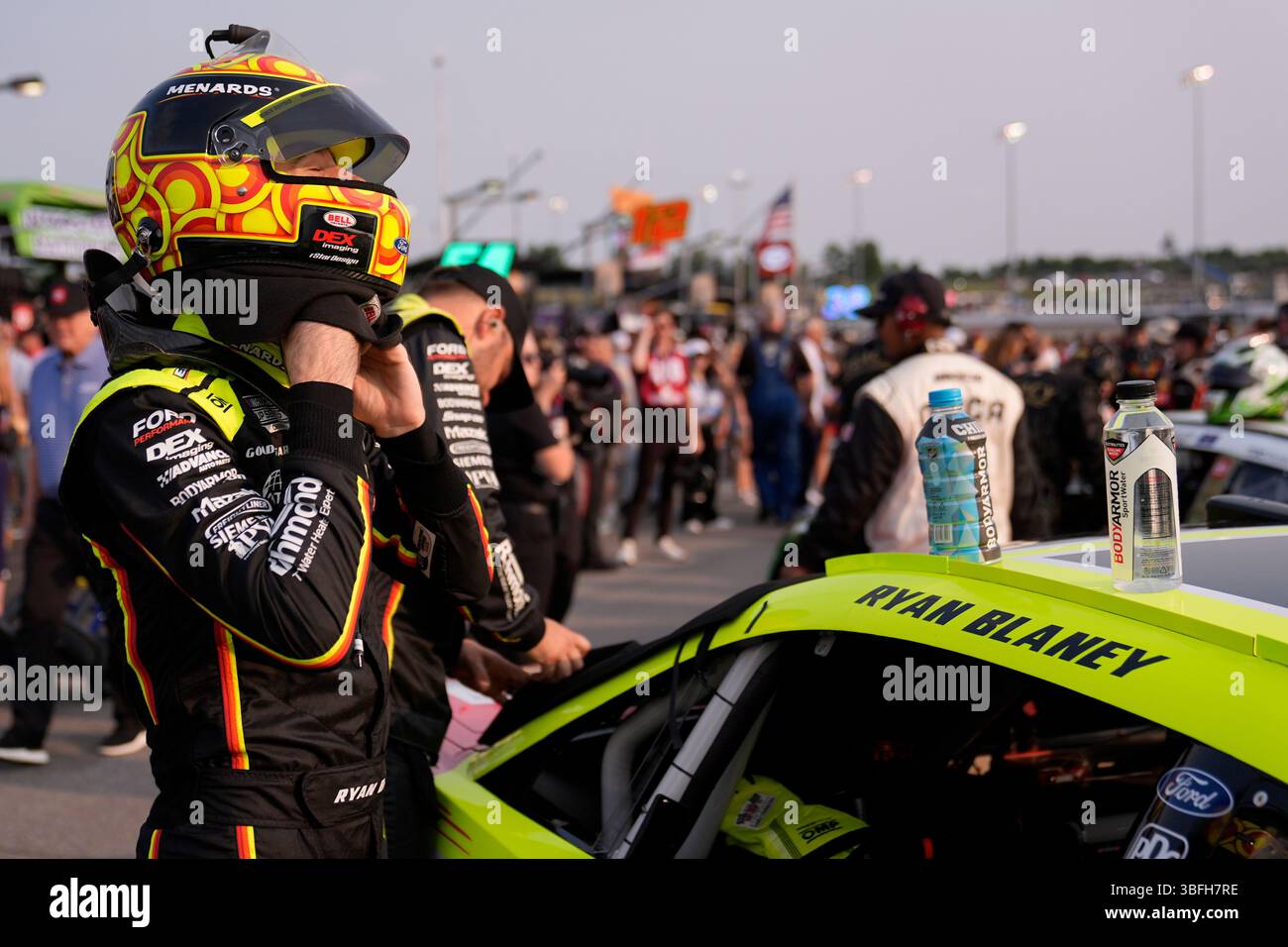 Ryan Blaney straps on his helmet before a NASCAR Cup Series auto race ...