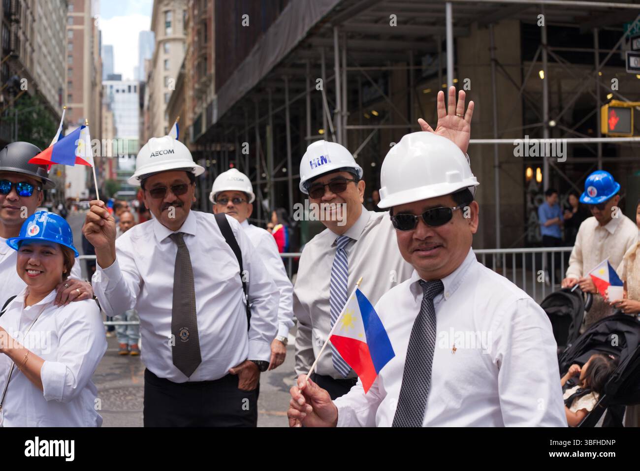 A group of Filipino men in white long-sleeved shirts and white hard ...