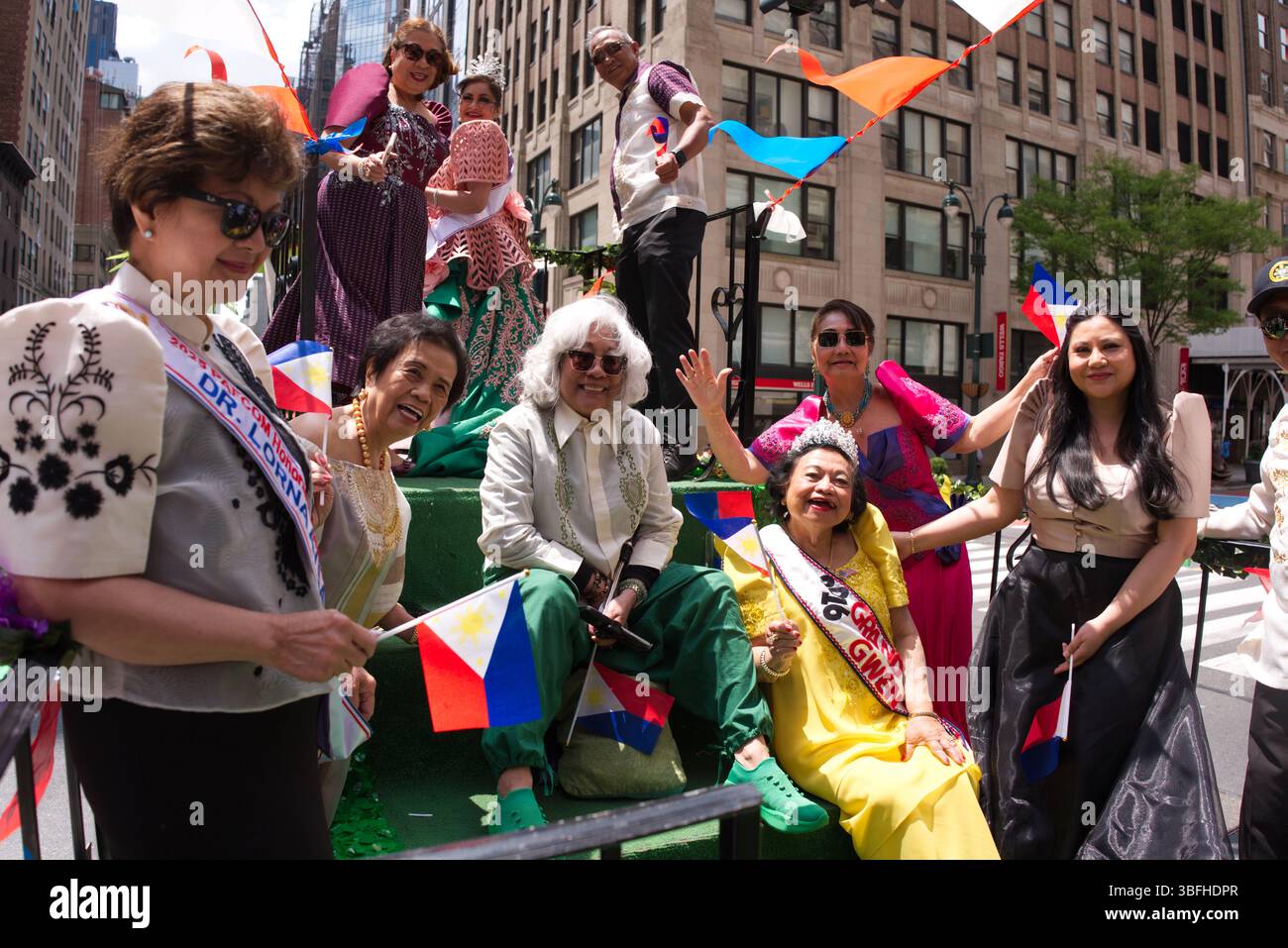 A group of Filipino women and men in traditional clothing participate ...