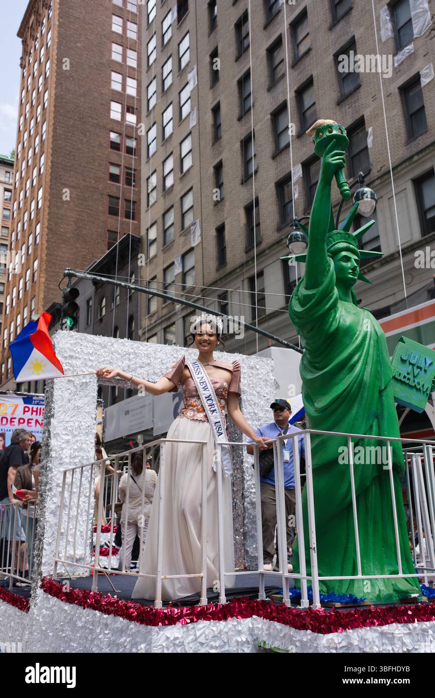 A Miss New York USA contestant stands on a parade float alongside a ...