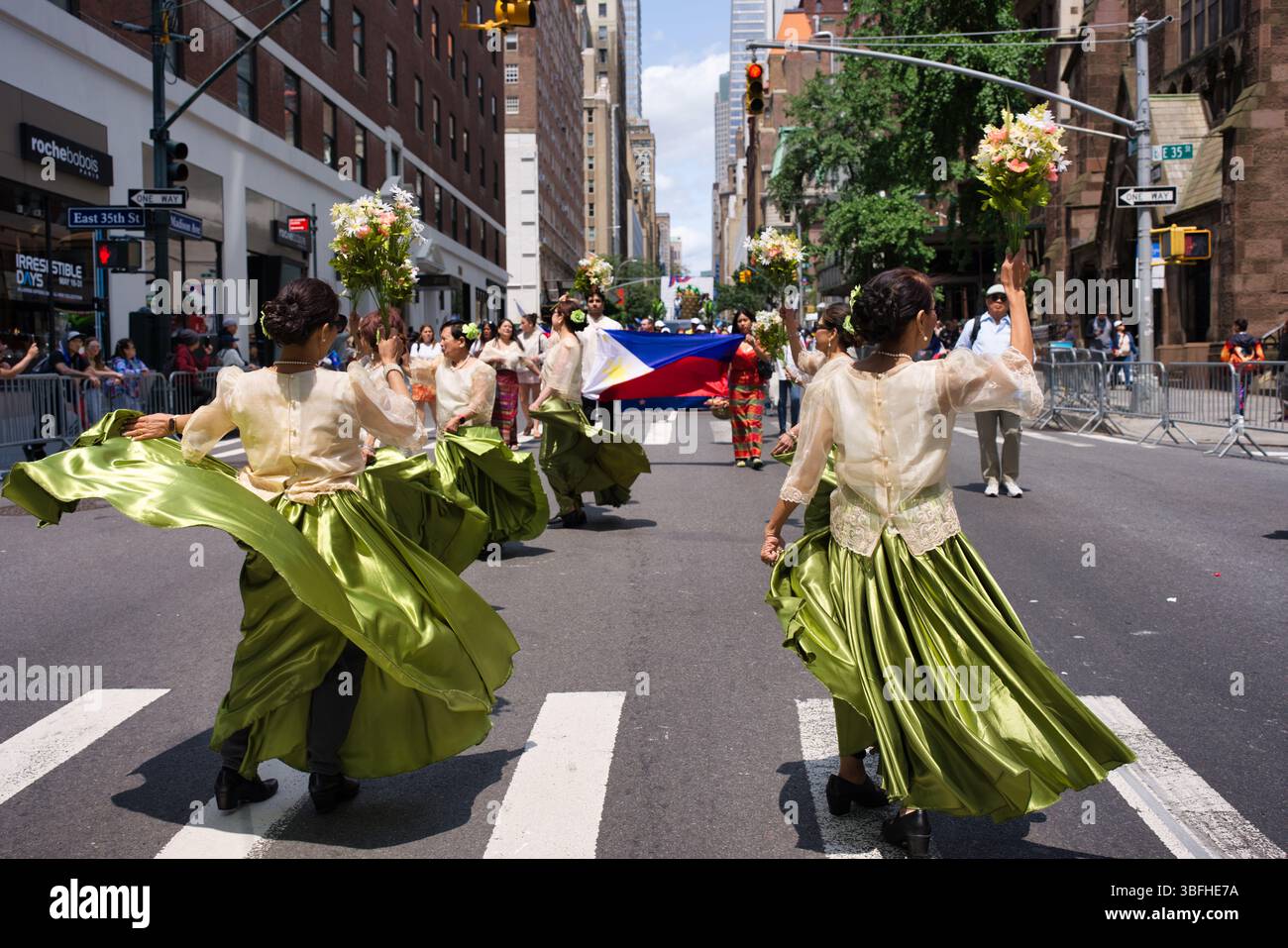 Philippine Independence Day parade in NYC. Women in flowing green satin ...