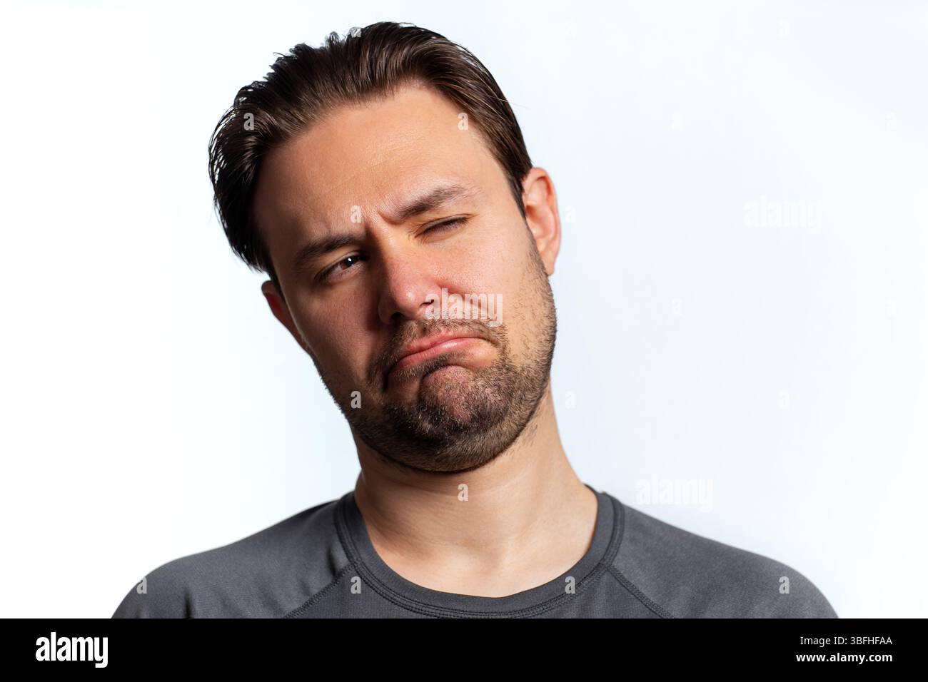 Man skeptical portrait isolated on white background Stock Photo - Alamy