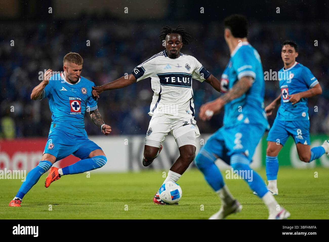 Jean-Claud Ngando of Canada's Vancouver Whitecaps, center, and Mateusz ...
