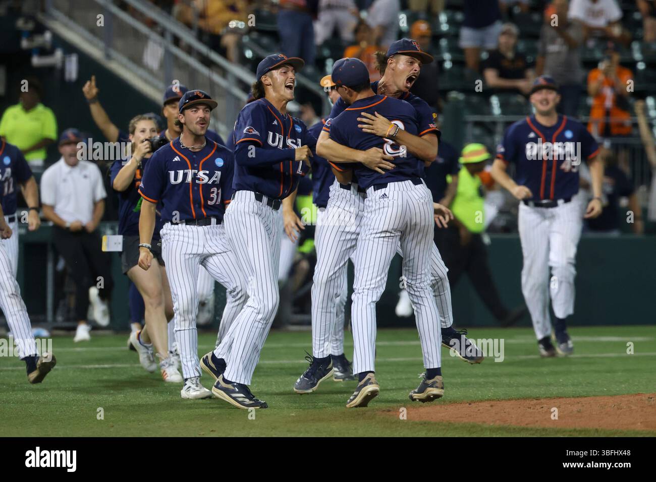 AUSTIN, TX - JUNE 01: UTSA players rush the field to celebrate winning ...