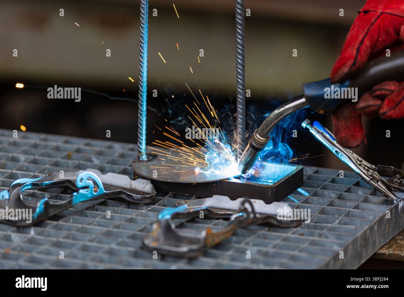 Details of welding activities - a welder is welding steel components ...