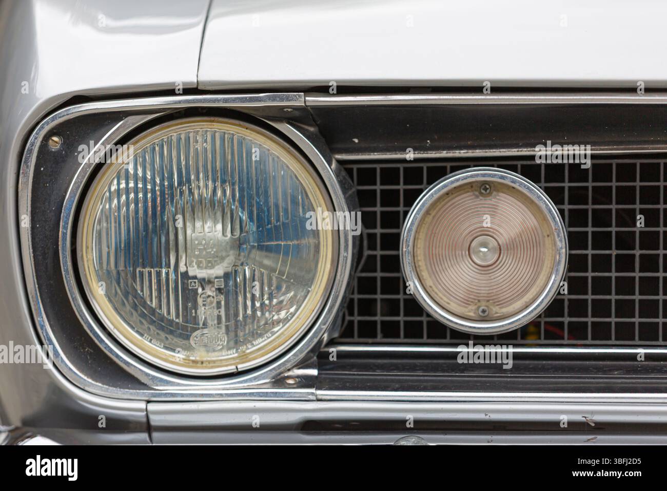 Head lamps with garnish moldings of a classic car Stock Photo - Alamy