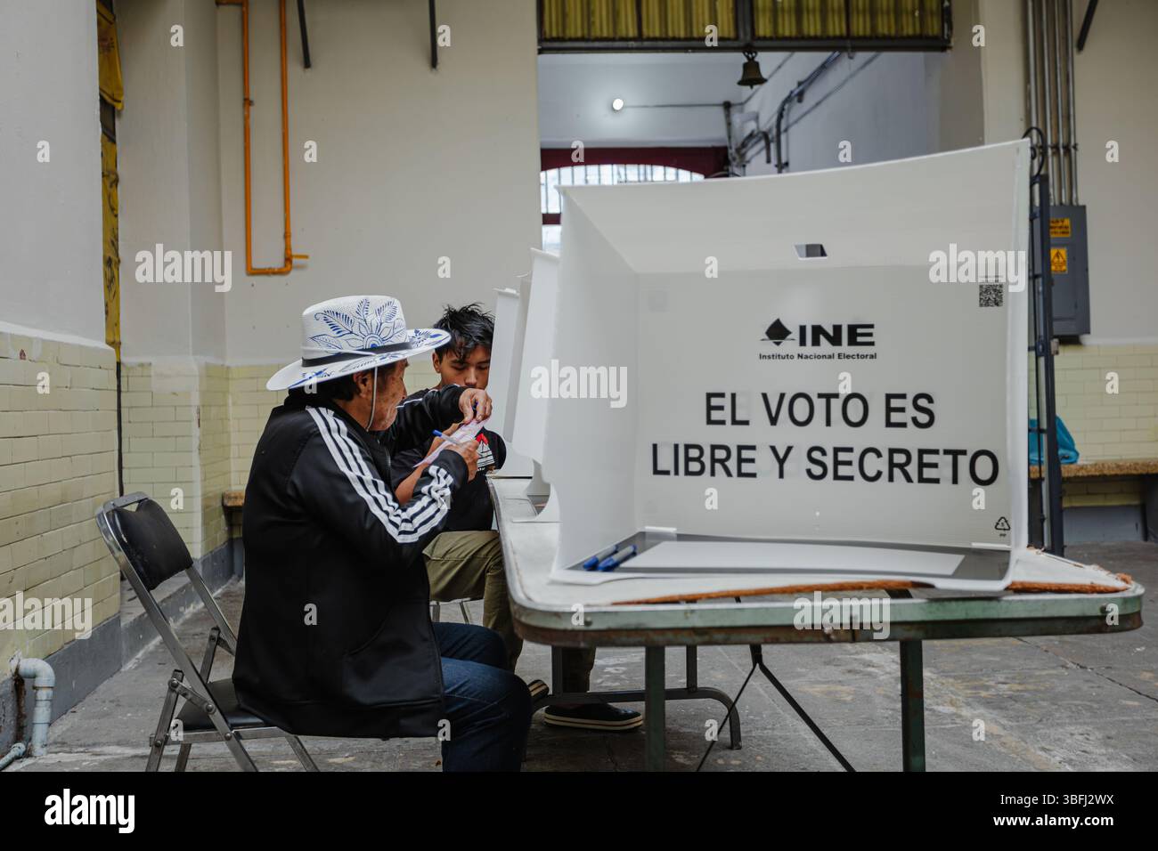 A citizen arrives at a polling station to cast their vote during Mexico ...