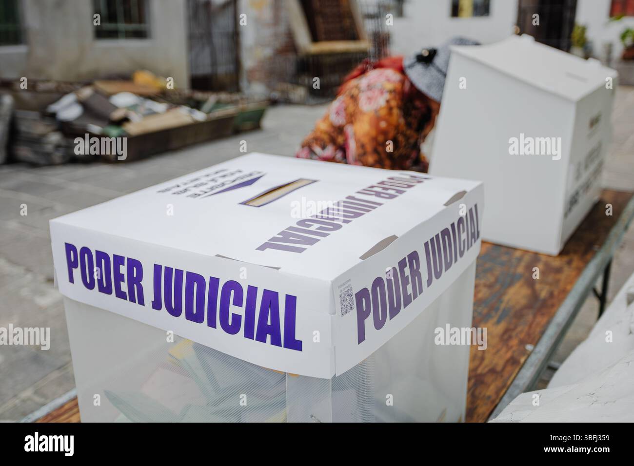 A transparent ballot box labeled “Poder Judicial” is displayed at a ...