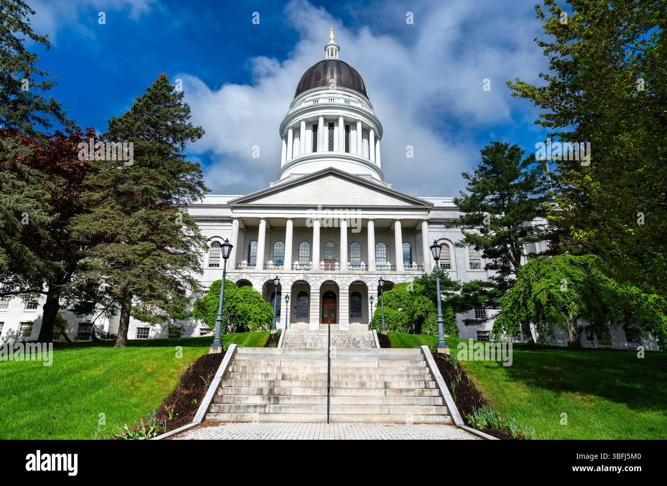 Classical white granite capitol building with a prominent dome and ...
