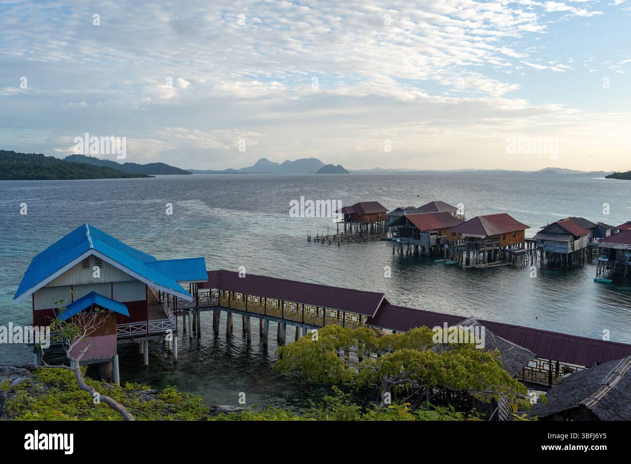 Traditional fishermen houses built on stilts over calm waters in the ...
