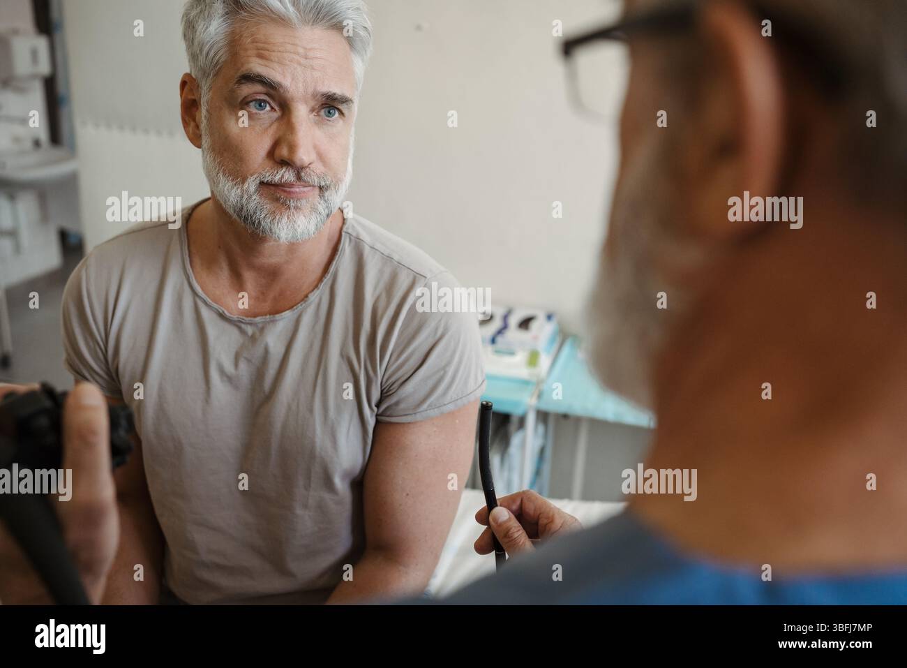 Doctor explaining gastroscopy procedure on patient. Examination of ...