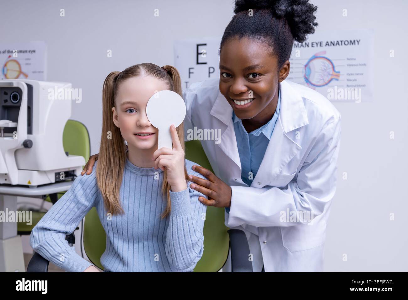 Fair-haired caucasian kid having eye test at optometrist office Stock ...