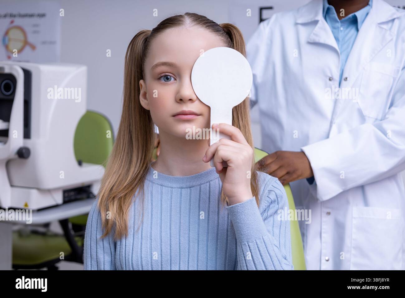 Fair-haired caucasian kid having eye test at optometrist office Stock ...
