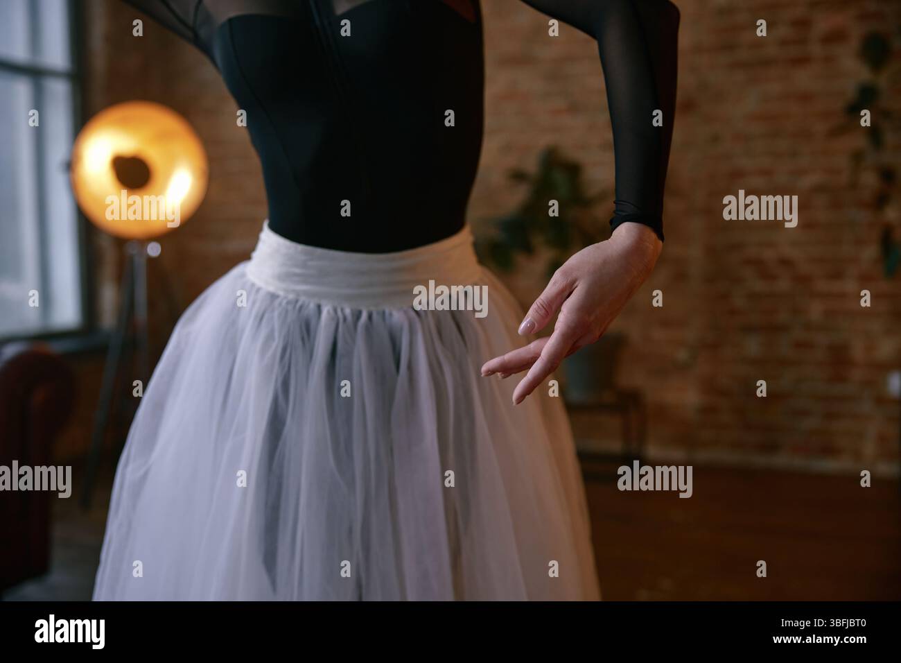 Elegant female dancer in an artistic pose set against a striking urban ...