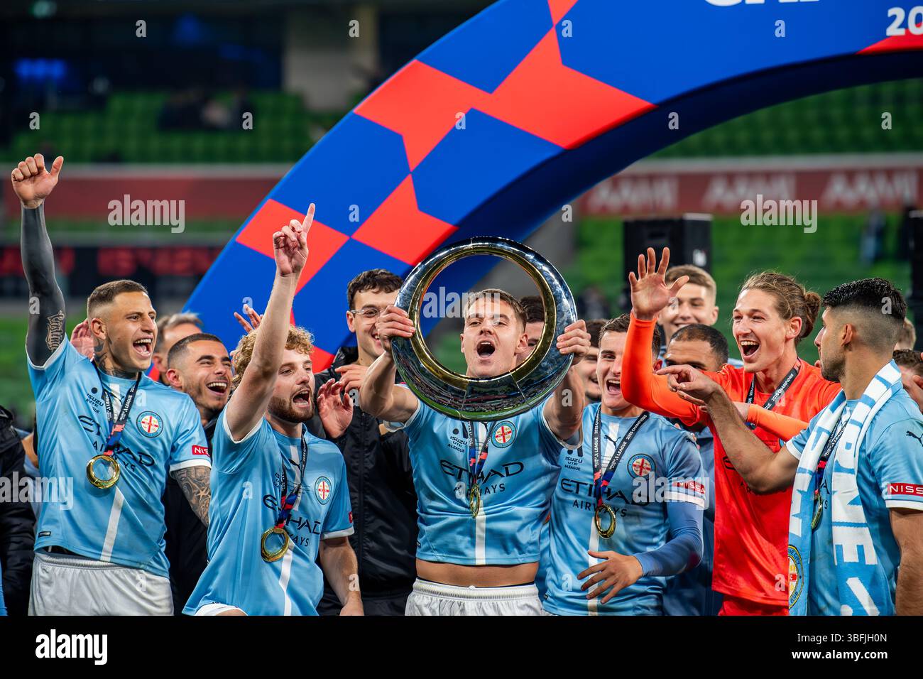 Max Caputo of Melbourne City seen celebrating with a trophy after ...