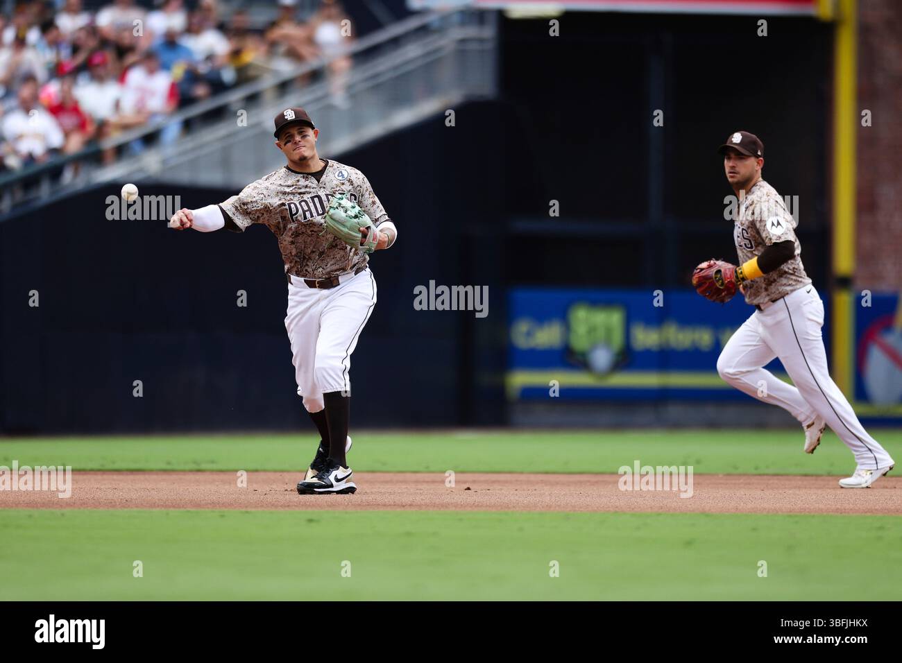 San Diego Padres third baseman Manny Machado, left, throws to first ...