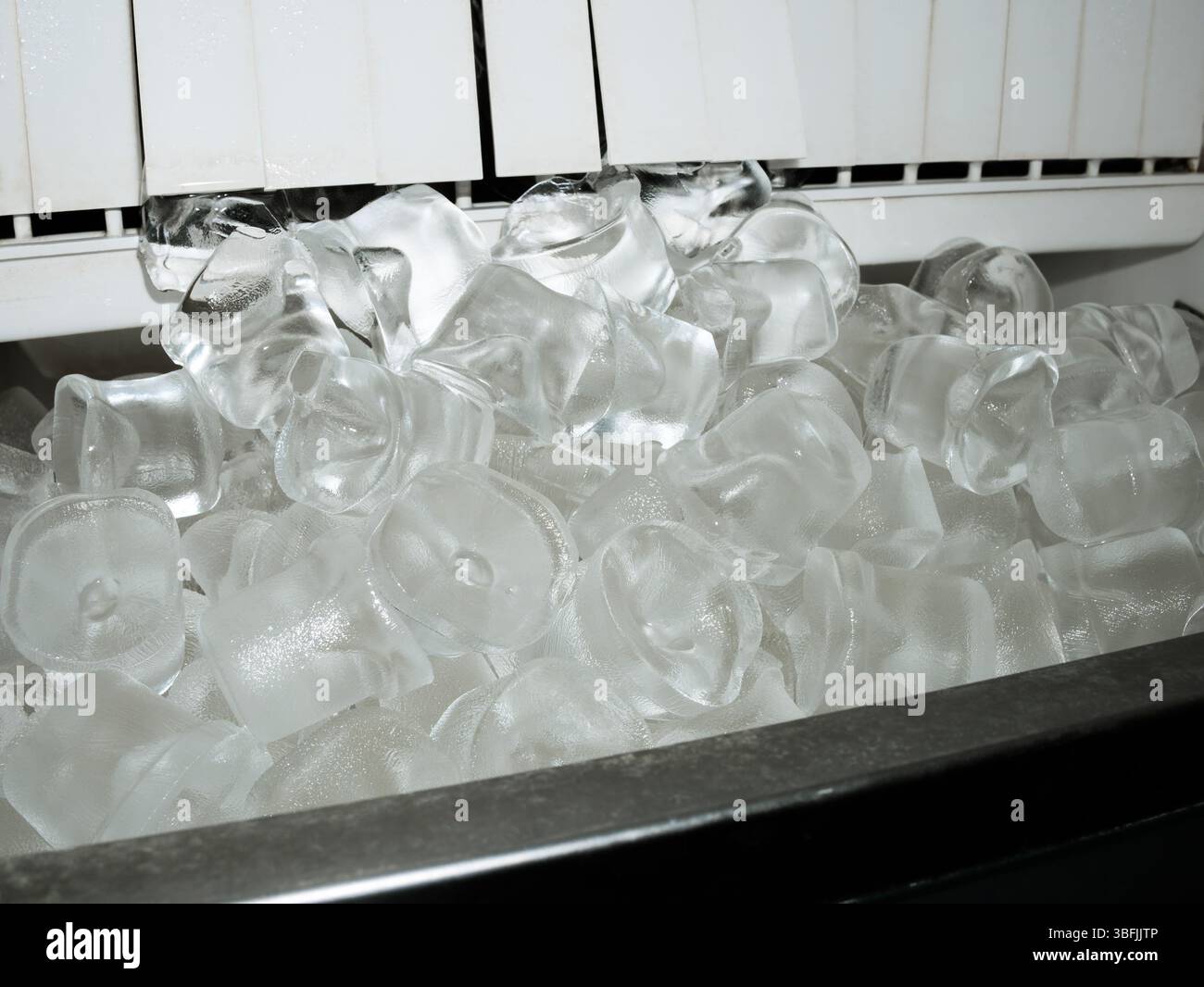 Molded ice cubes inside the ice maker Stock Photo - Alamy