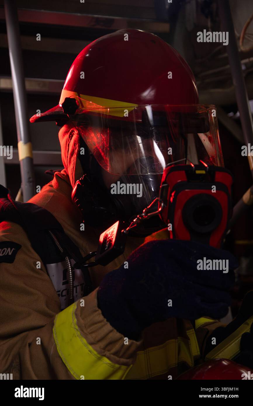 A Sailor utilizes the naval firefighting thermal imager during a damage ...