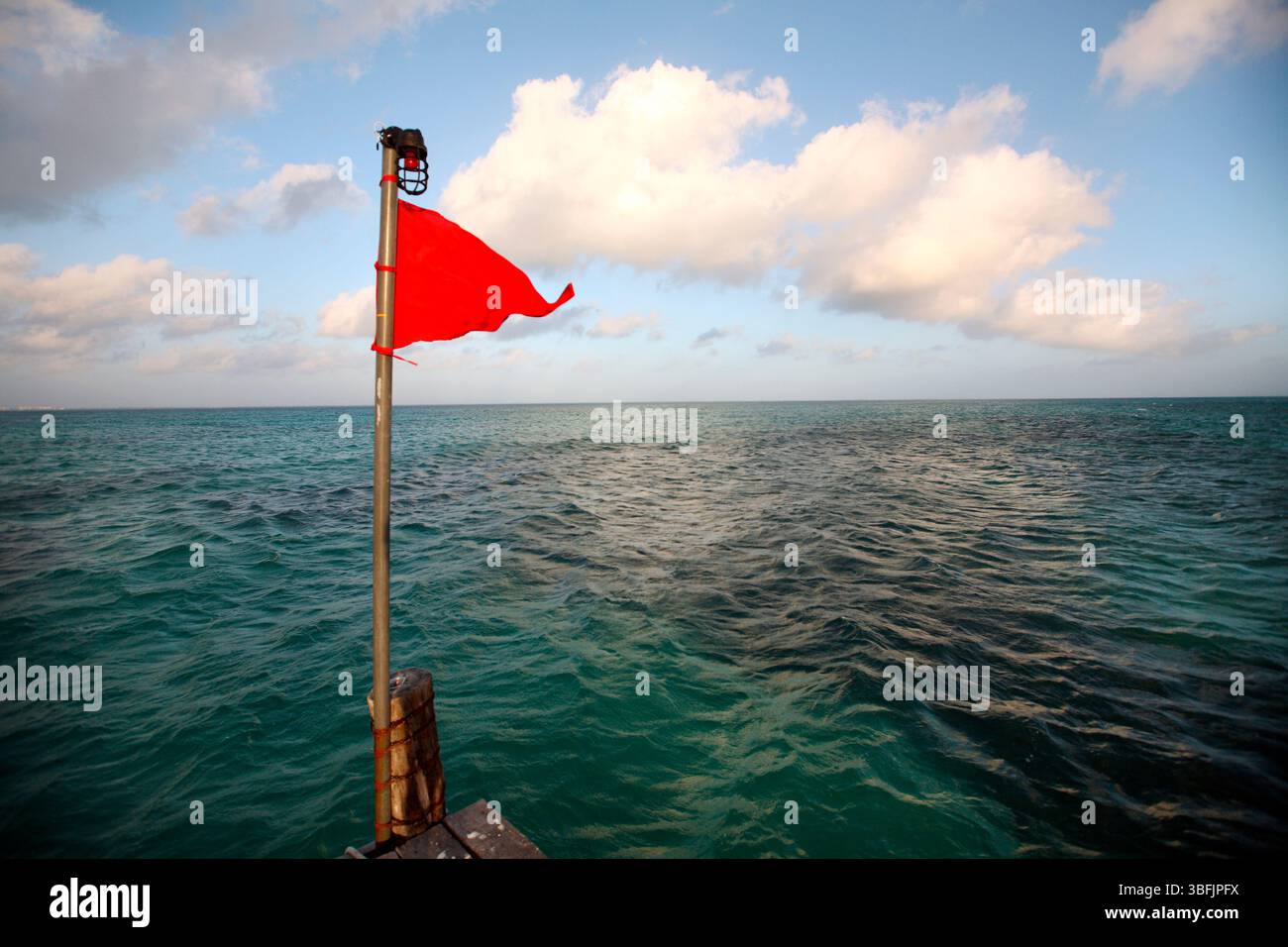Dock and flag on Isla Mujeres, Cancun, Mexico Stock Photo - Alamy