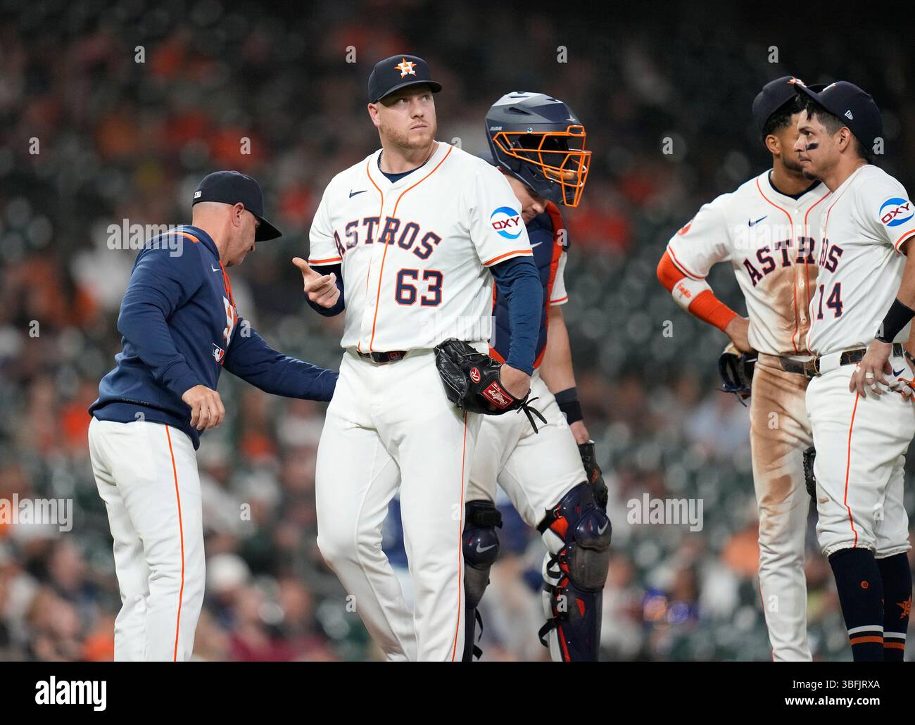 Houston Astros manager Joe Espada, left, pulls relief pitcher Kaleb Ort ...