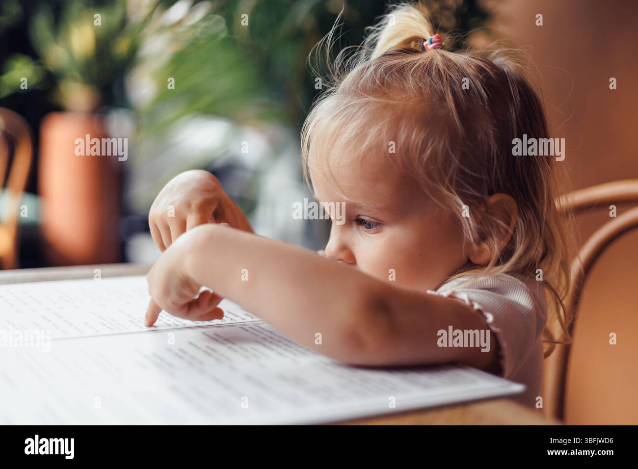 Exploring menu in cozy cafe hi-res stock photography and images - Alamy