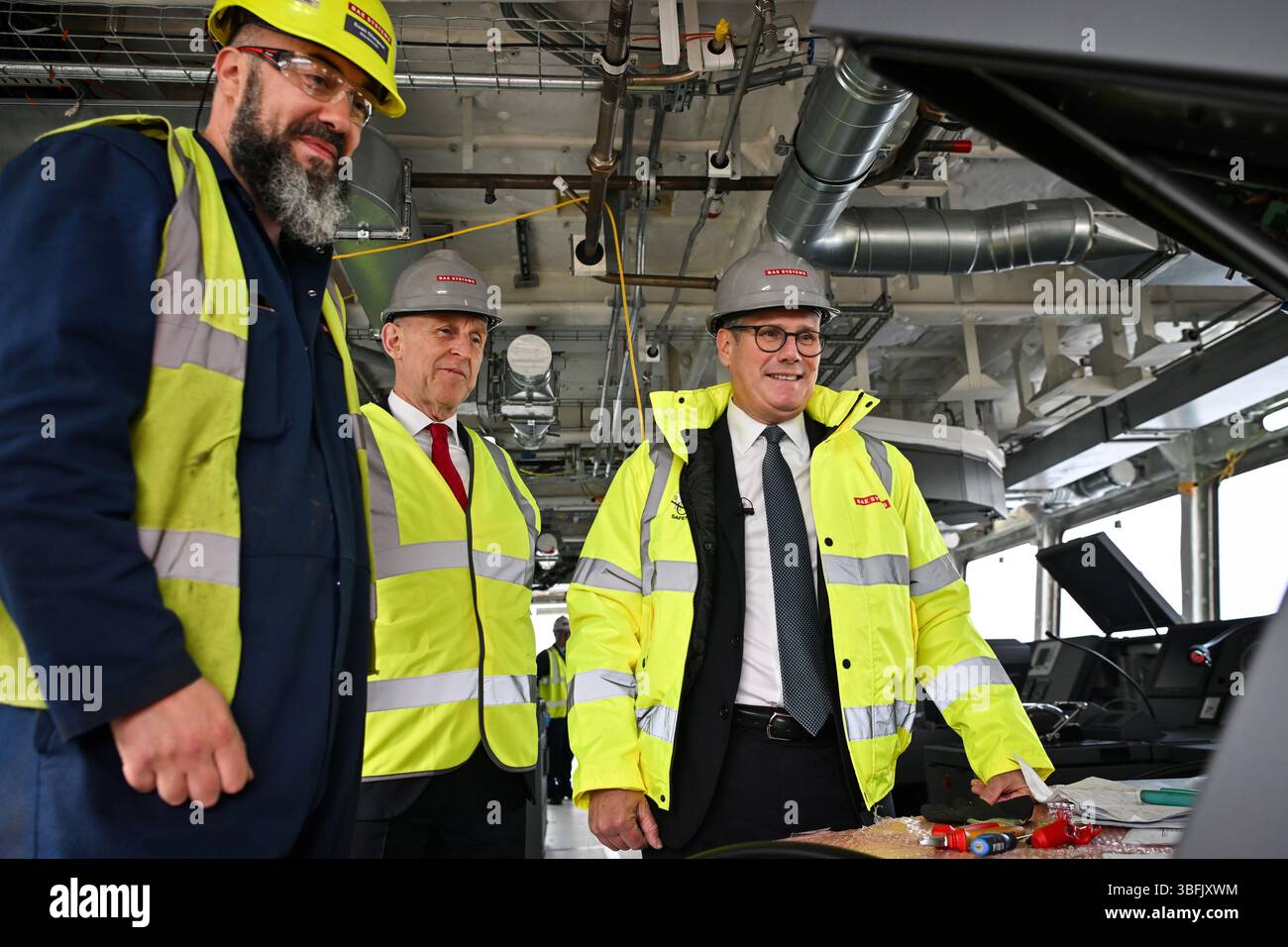 Defence Secretary John Healey (centre) and Prime Minister Sir Keir ...
