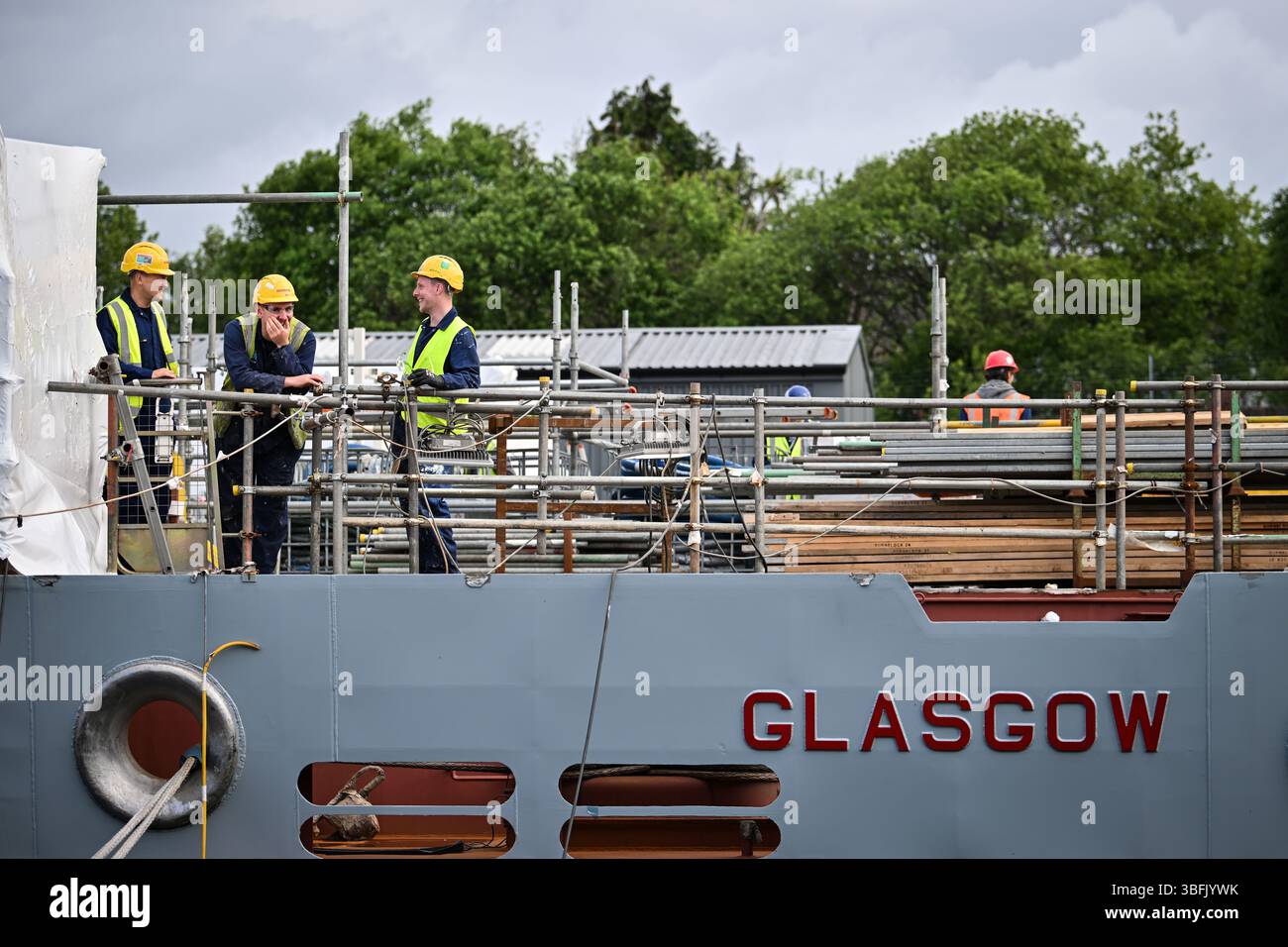 Members of staff watch Prime Minister Sir Keir Starmer during a visit ...