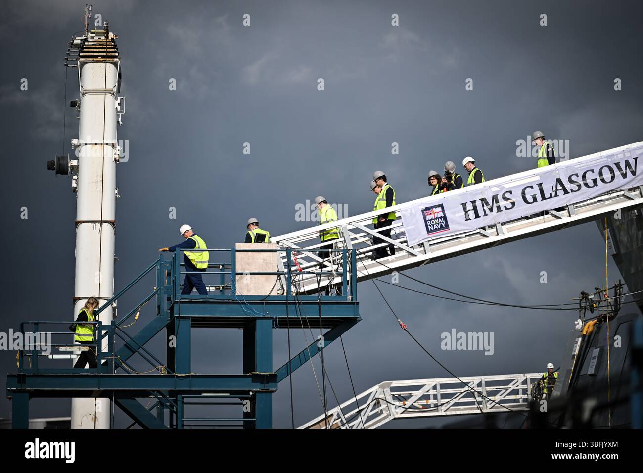 Members of staff watch Prime Minister Sir Keir Starmer during a visit ...