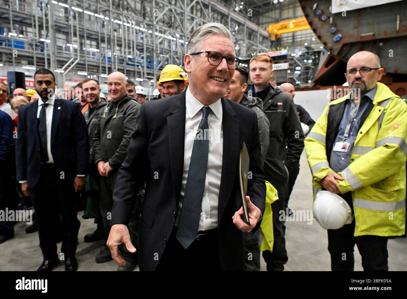Britain's Prime Minister Keir Starmer speaks with members of staff as ...