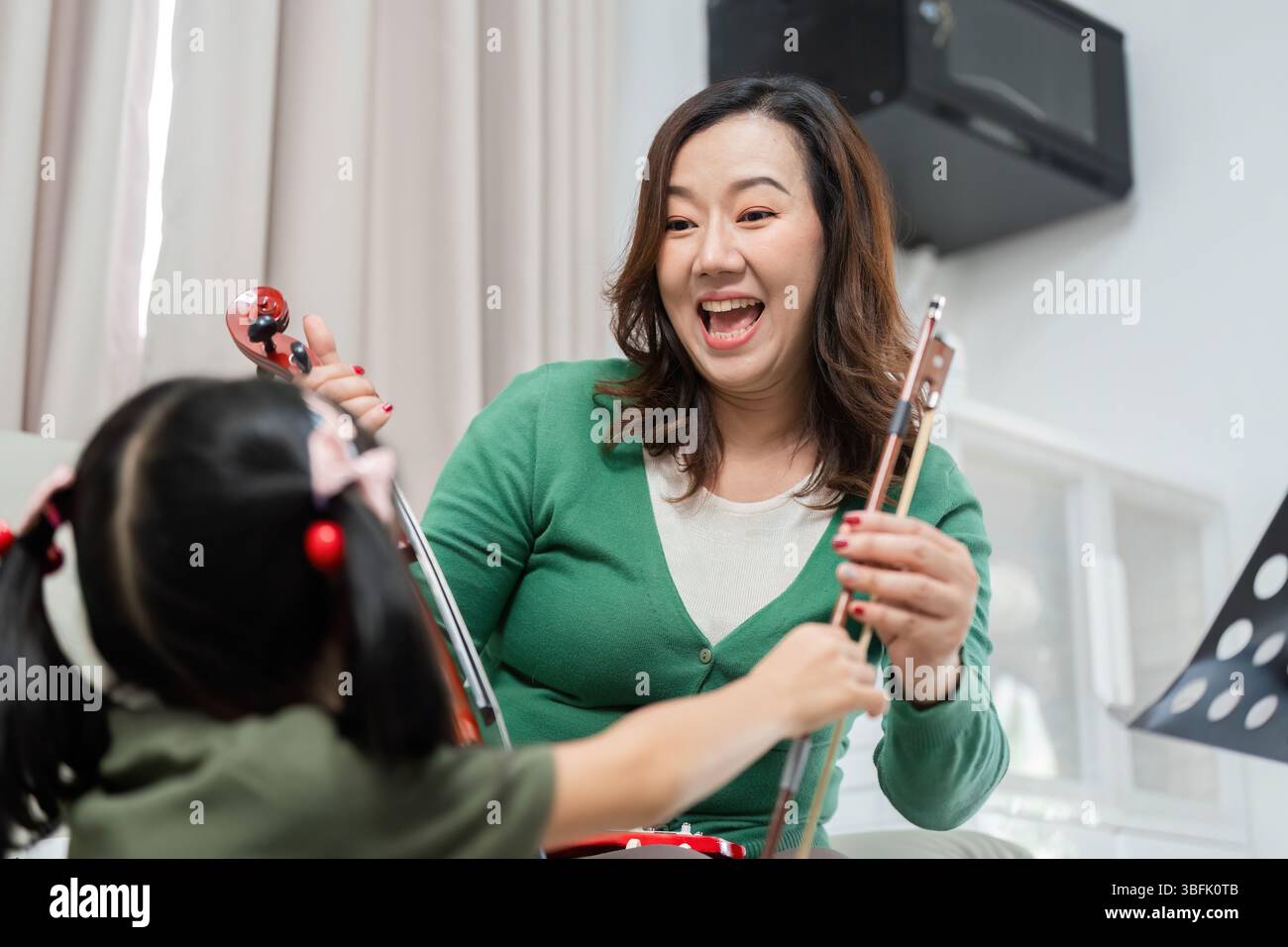 Music Education and Joyful Learning. A mother and daughter sharing a ...