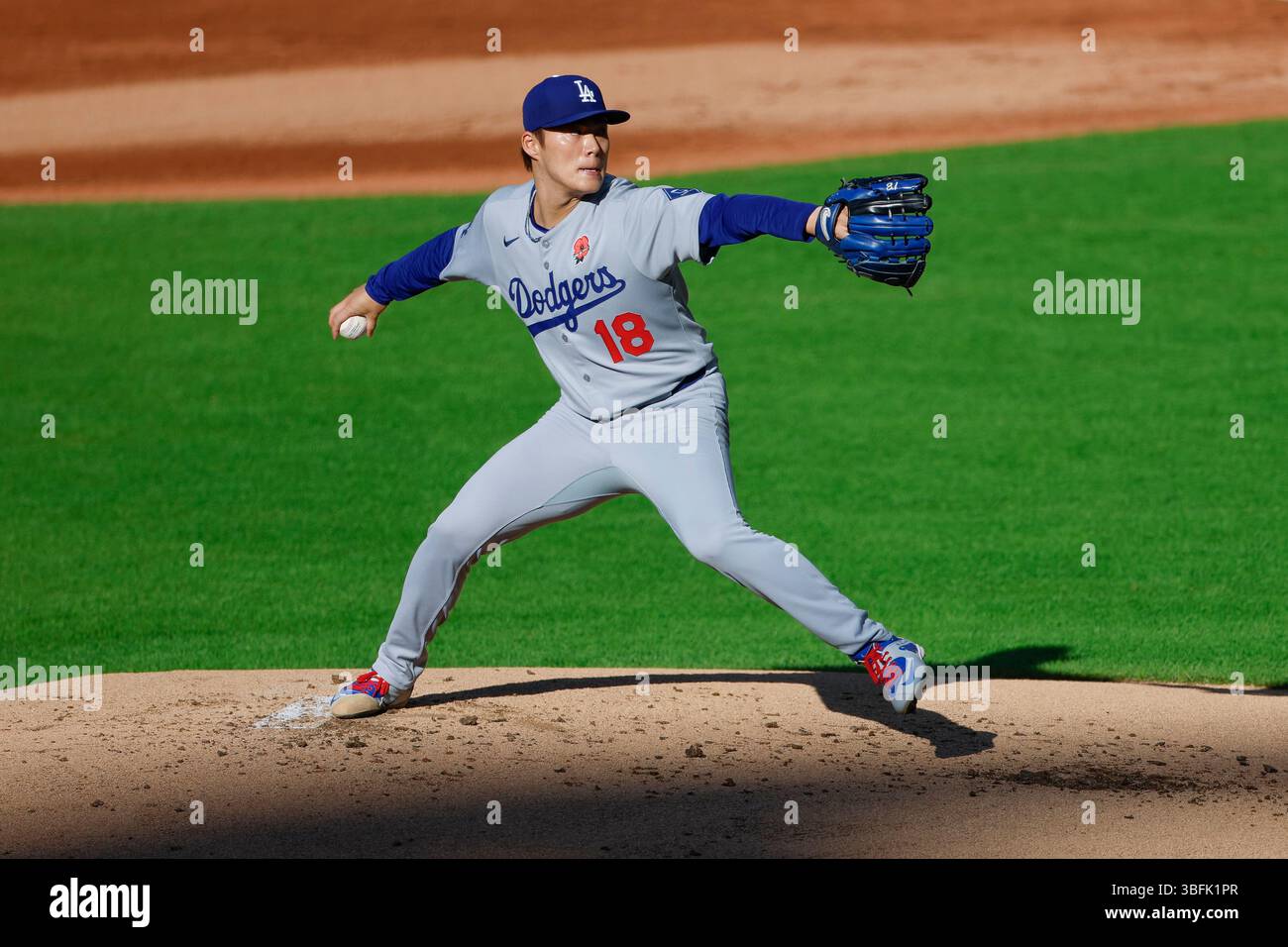Yoshinobu Yamamoto #18 of the Los Angeles Dodgers throws a pitch during ...