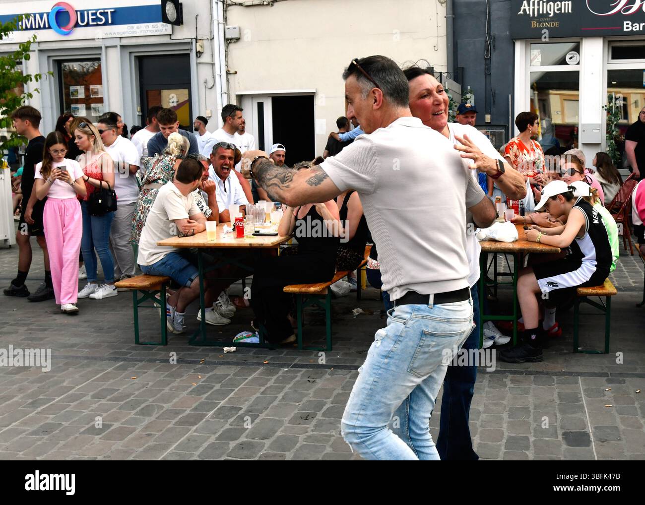 Couples dancing in the street during May Day La Fête du Muguet (Lilly ...