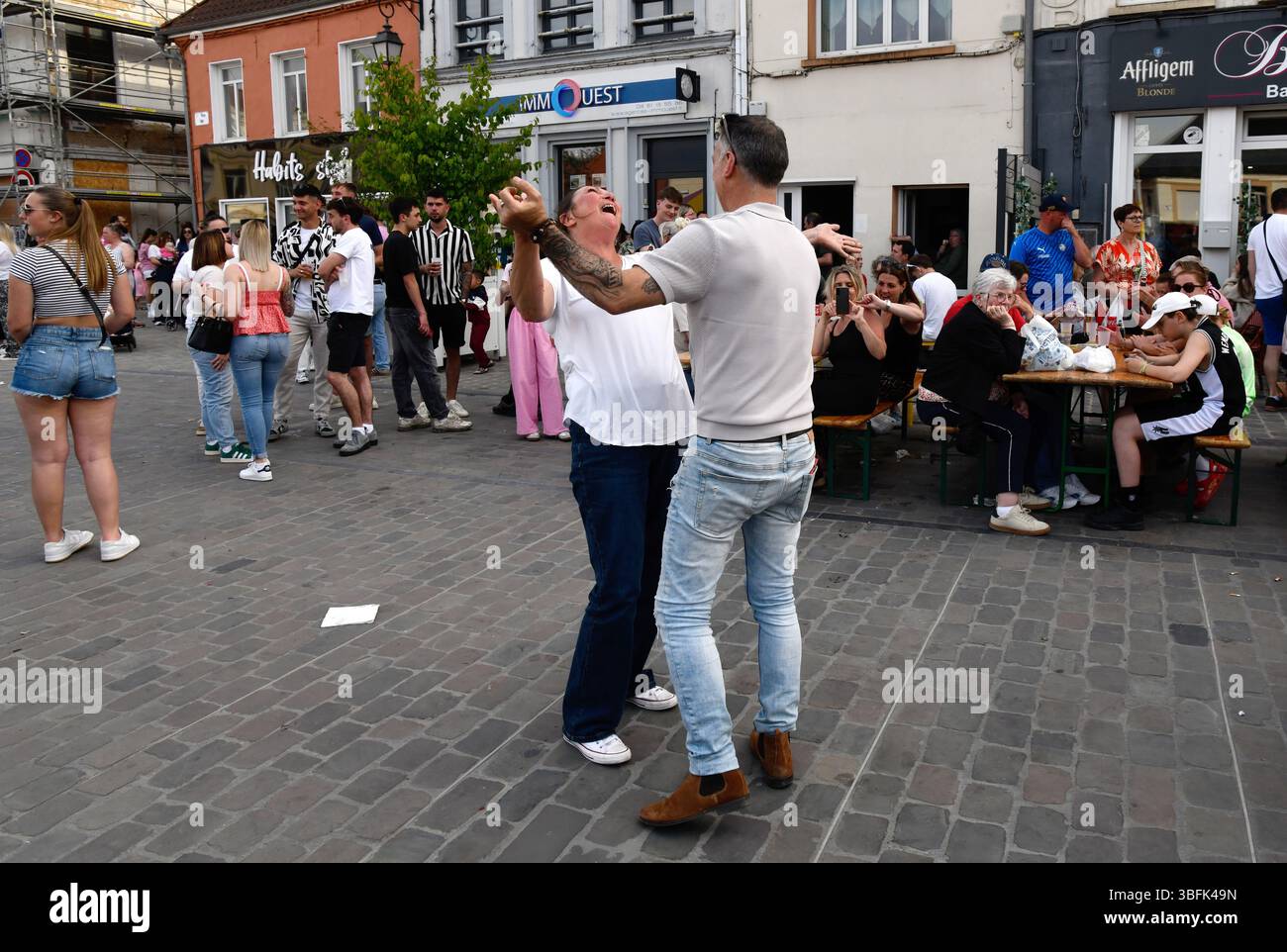 Couples dancing in the street during May Day La Fête du Muguet (Lilly ...