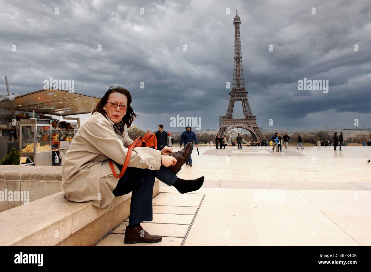 Paris 2006 Woman with tired feet at the Trocadero in Paris France ...