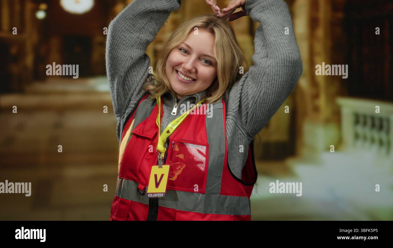 Woman volunteer in red vest hi-res stock photography and images - Alamy