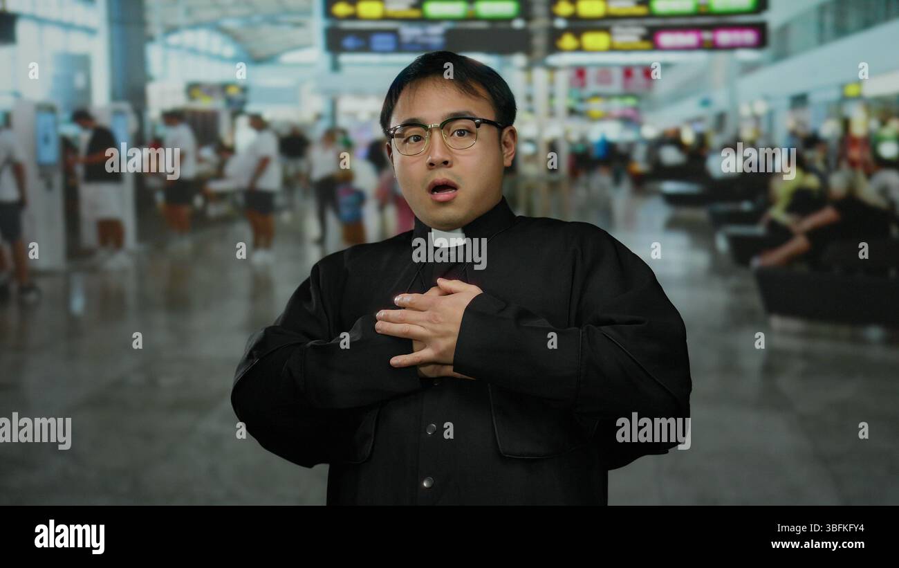 Chinese priest in a bustling airport terminal displaying a worried ...