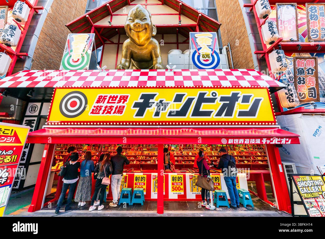Japanese shooting Gallery in the tourist area of Shinsekai. People at ...