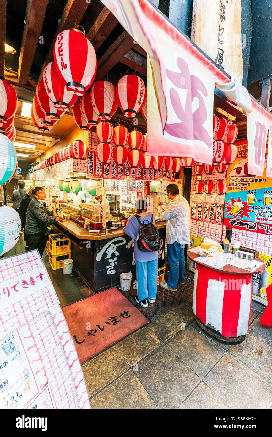 Several customers at the food bar of a typical Japanese diner. The ...