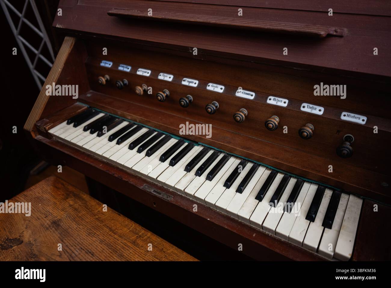 Wooden antique keyboard instrument with labeled sound settings and ...
