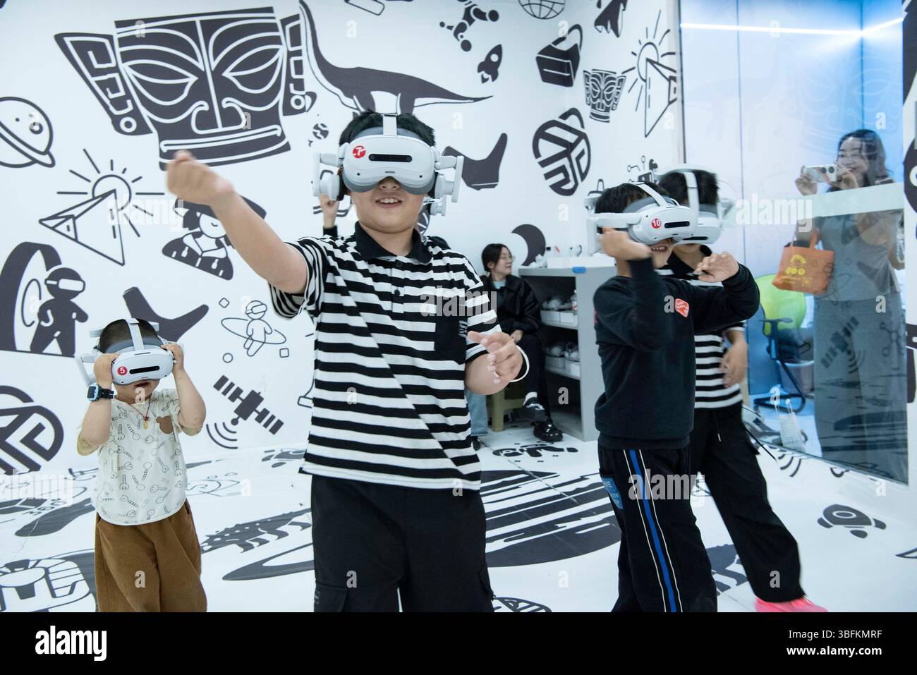 HAIAN, CHINA - JUNE 2, 2025 - Children are experiencing in a VR ...